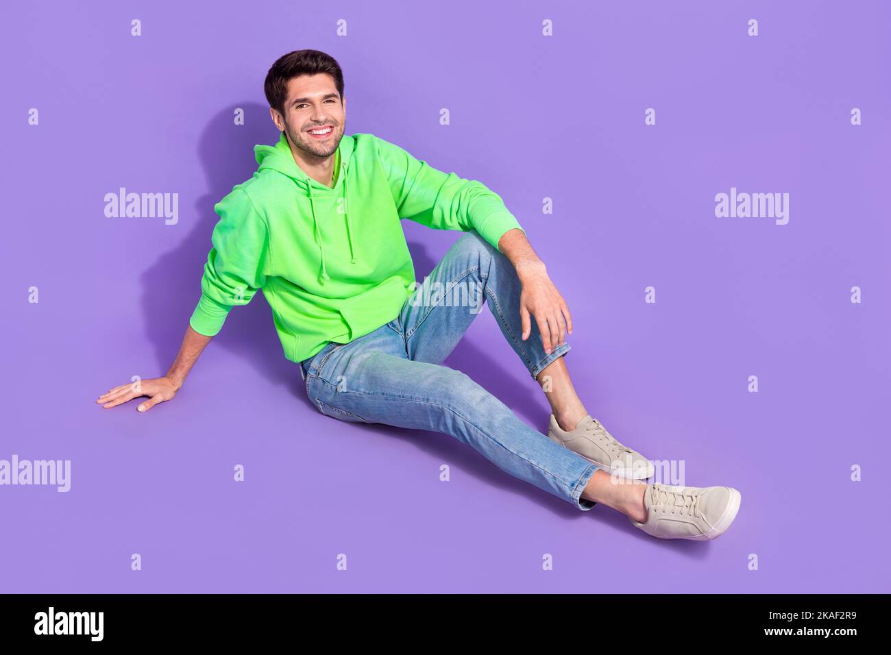 Full length photo of funky adorable man wear green sitting floor having ...