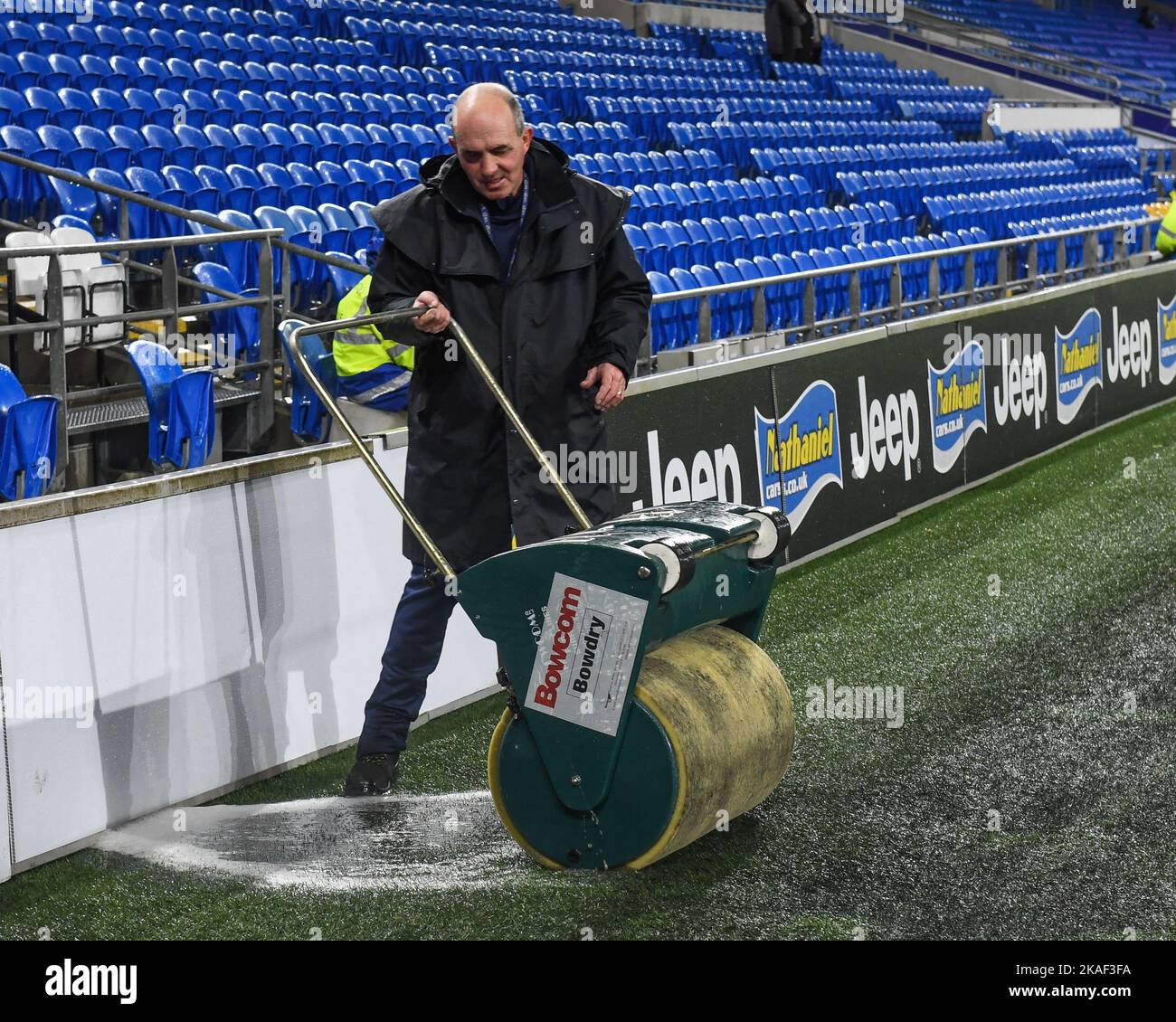 Ground staff work on the pitch after heavy rain before the Sky Bet ...