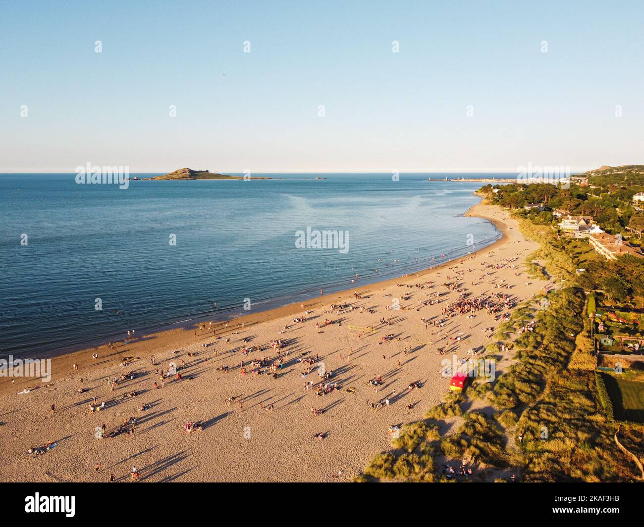 Long shadows from a busy Burrow Beach on a fine July evening Stock ...