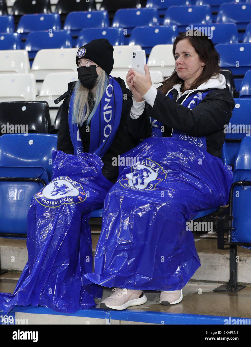 London, England, 29th October 2022. Chelsea fans cover their legs with ...