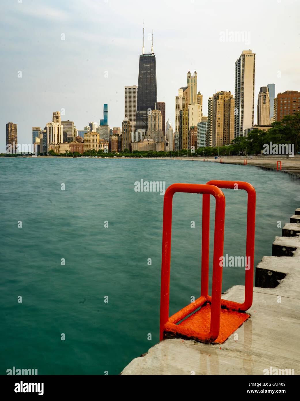 A vertical shot of Chicago Downtown with high skyscrapers in cloudy sky ...