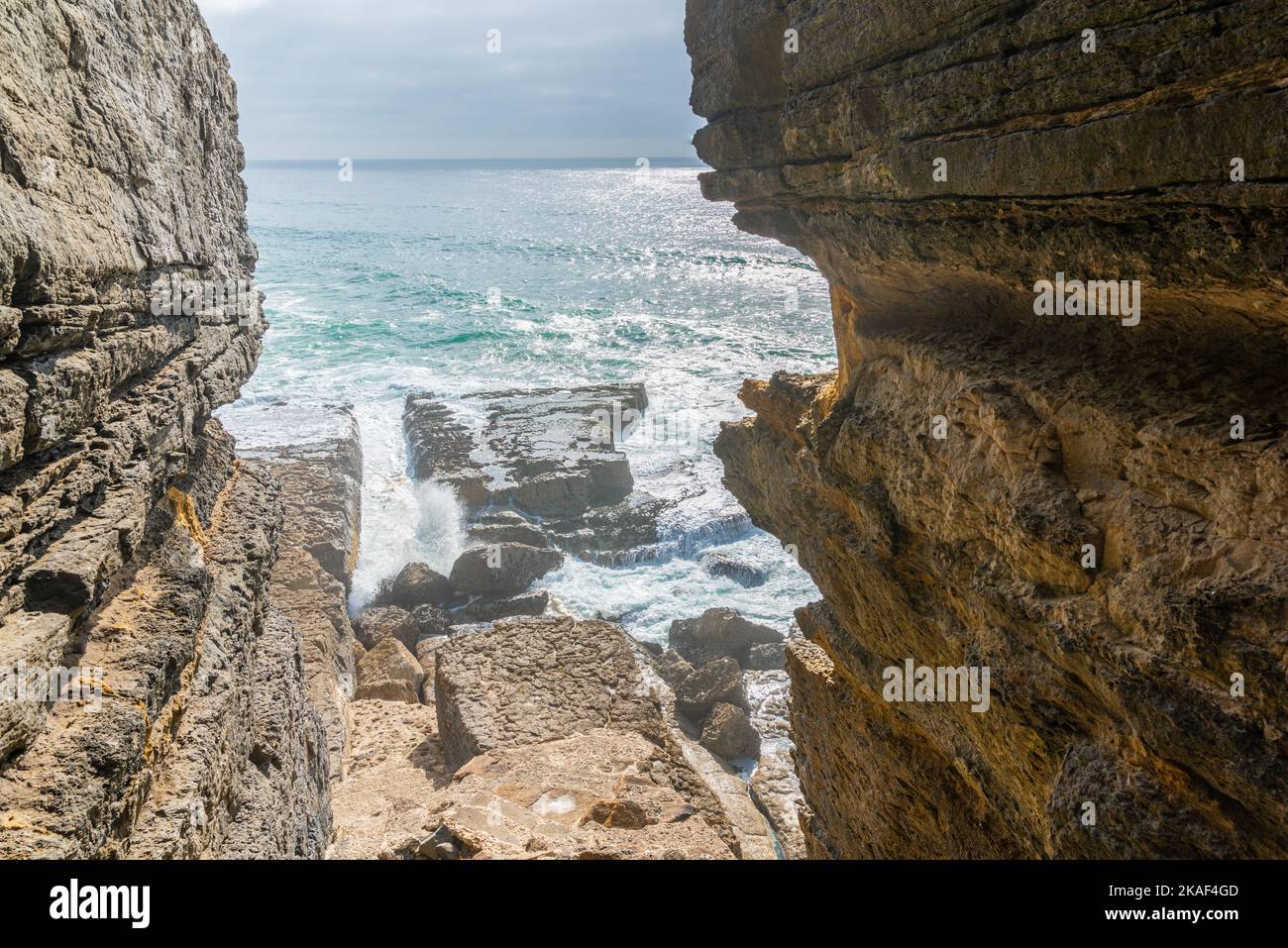 A natural crack in the rock overlooking the ocean at Magoito in Sintra ...