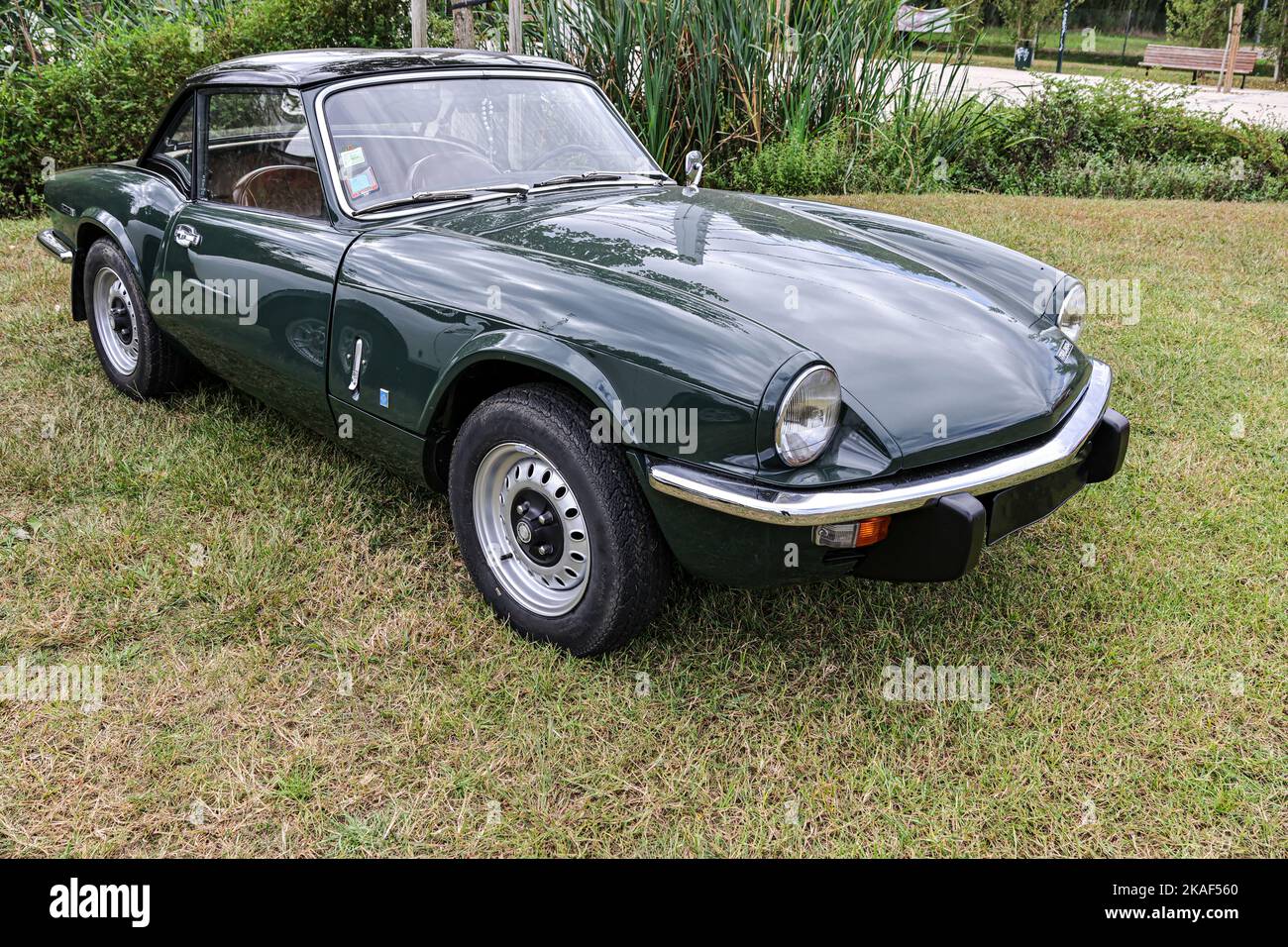 A vintage historic Triumph convertible car parked on a grassy meadow ...