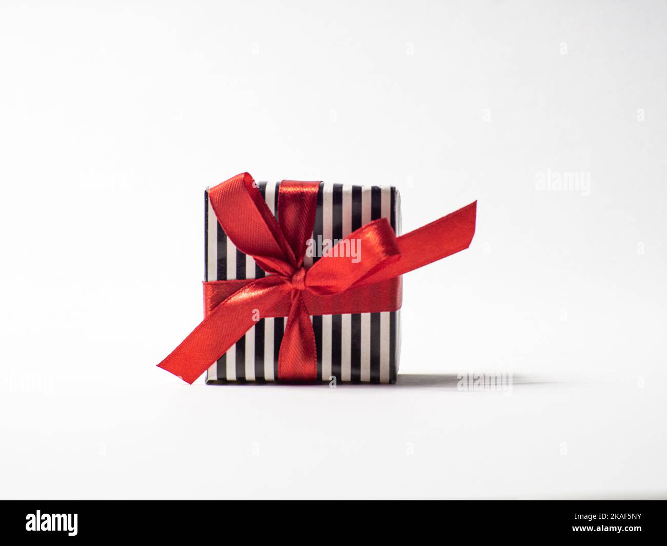Black gift box red ribbon hi-res stock photography and images - Alamy