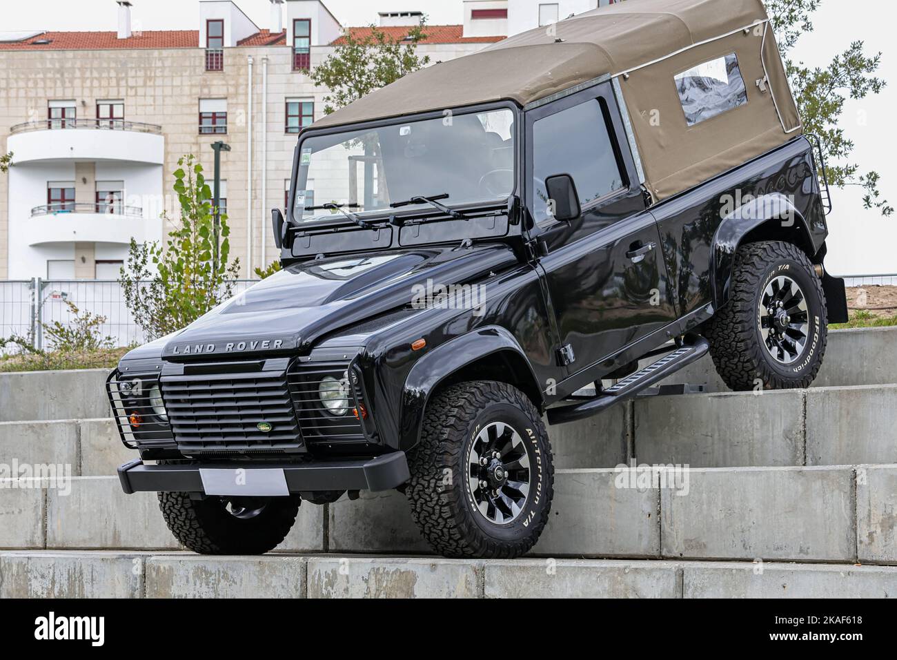 A black Land Rover Defender off-road jeep on concrete stairways during ...