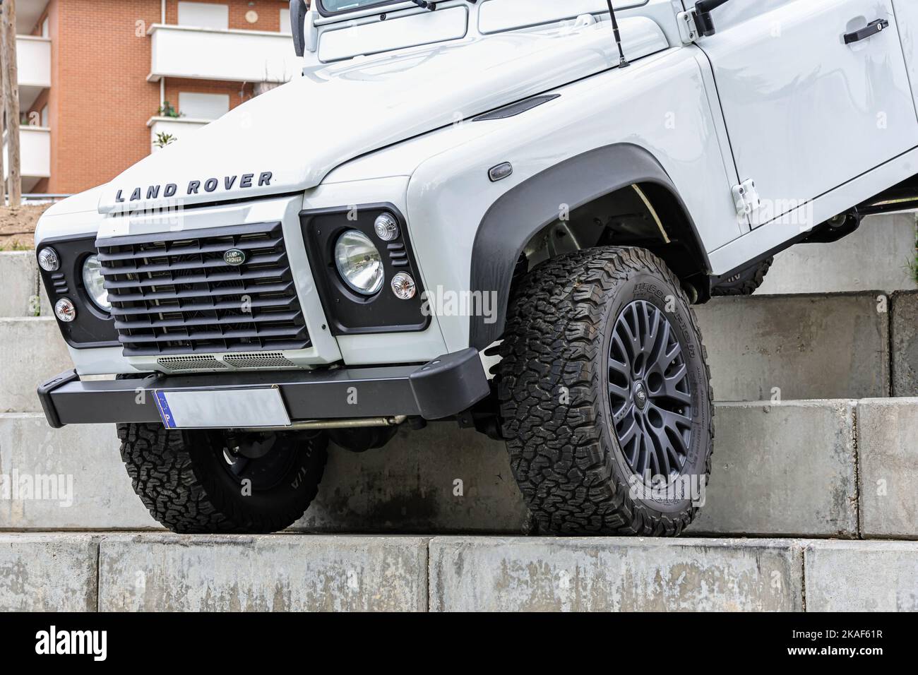 A white Land Rover Defender off-road jeep on concrete stairways during ...