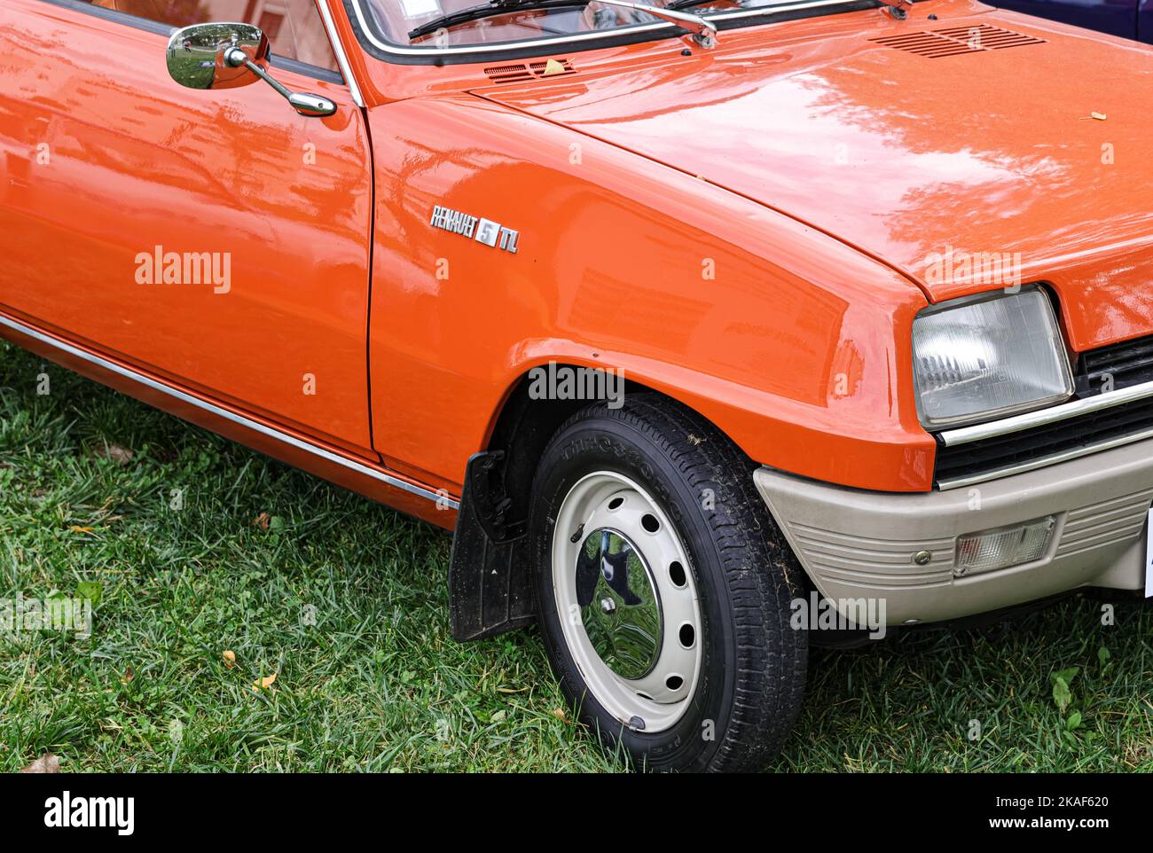 A closeup of orange historic Renault 5 car during an exhibition in a ...