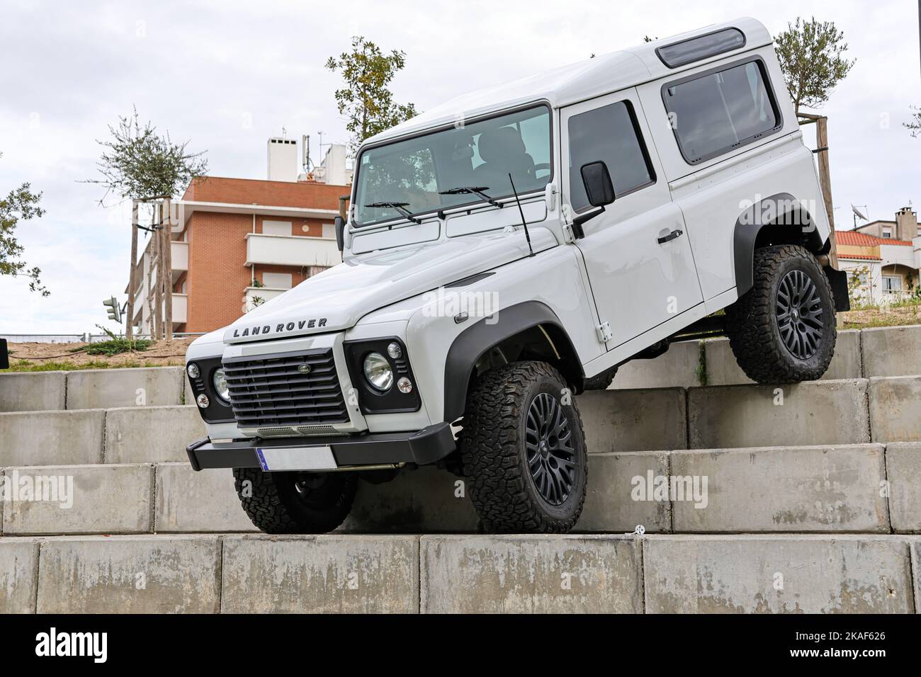 A white Land Rover Defender off-road jeep on concrete stairways during ...