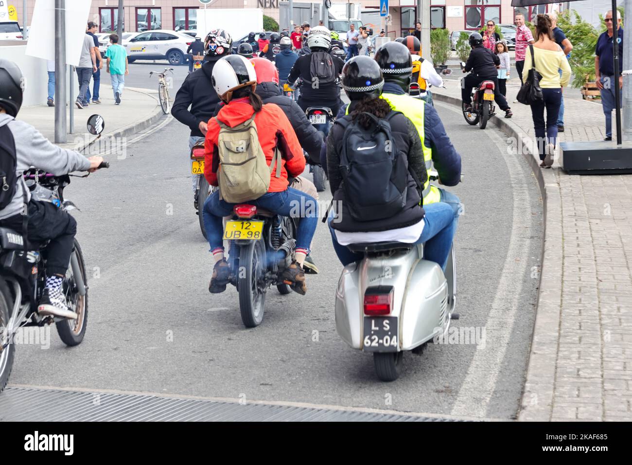 A group of people riding around on Vespa, zundapp, Famel XF, Piaggio ...