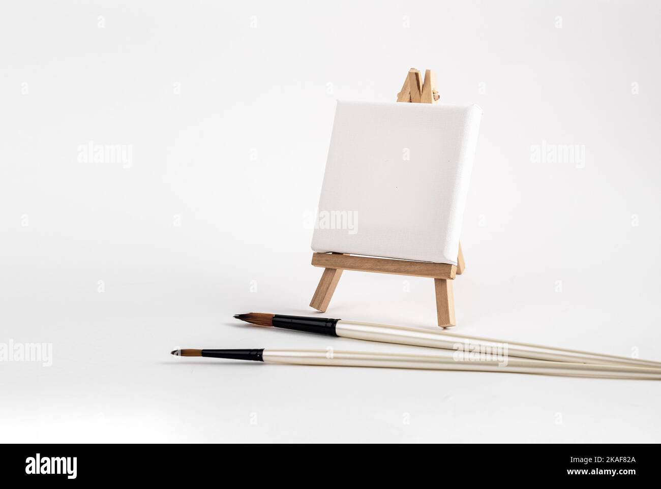 mini blank canvas and paintbrush with copyspace, conceptual stil-life ...