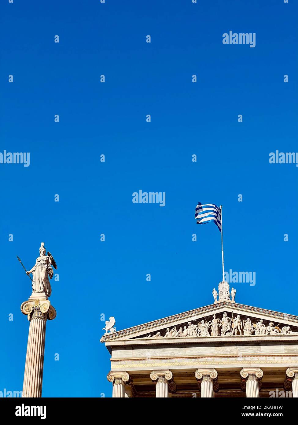 The greek flag on the top of Academy of Athens university on blue sky ...