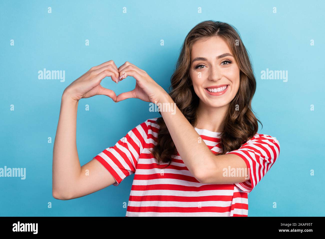 Photo of adorable shiny lady wear striped t-shirt smiling showing arms ...
