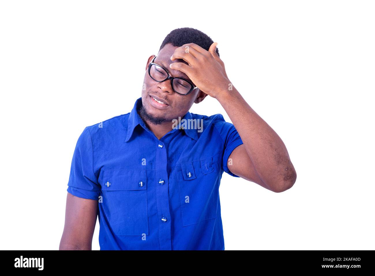 serious young man wearing optical glasses, holding hand on forehead ...