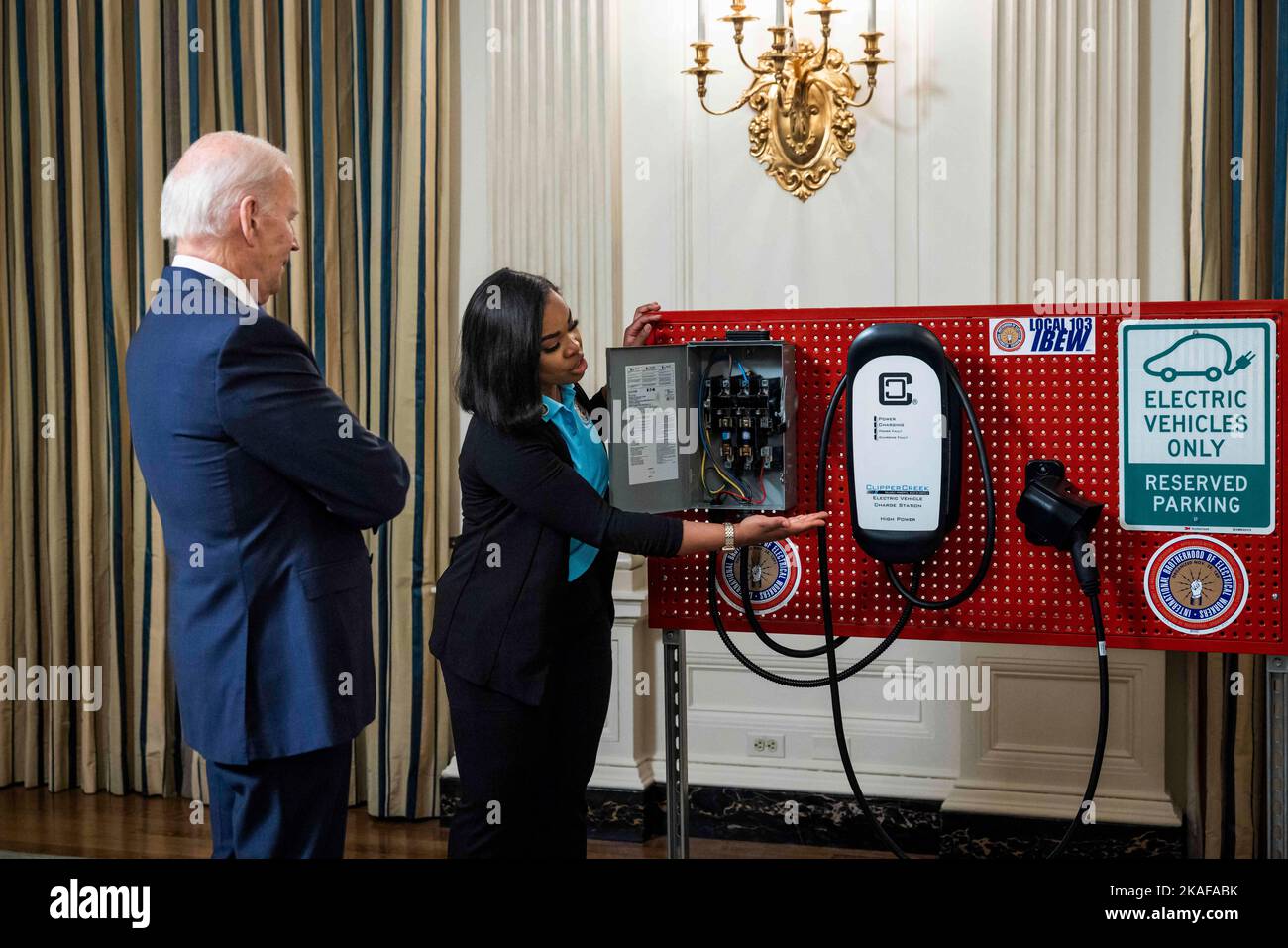 US President Joe Biden looks at an EV charger during a ‘workforce ...