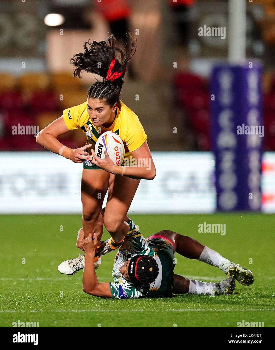 Australia’s Olivia Kernick is tackled by Cook Islands’ Kimiora Breayley ...