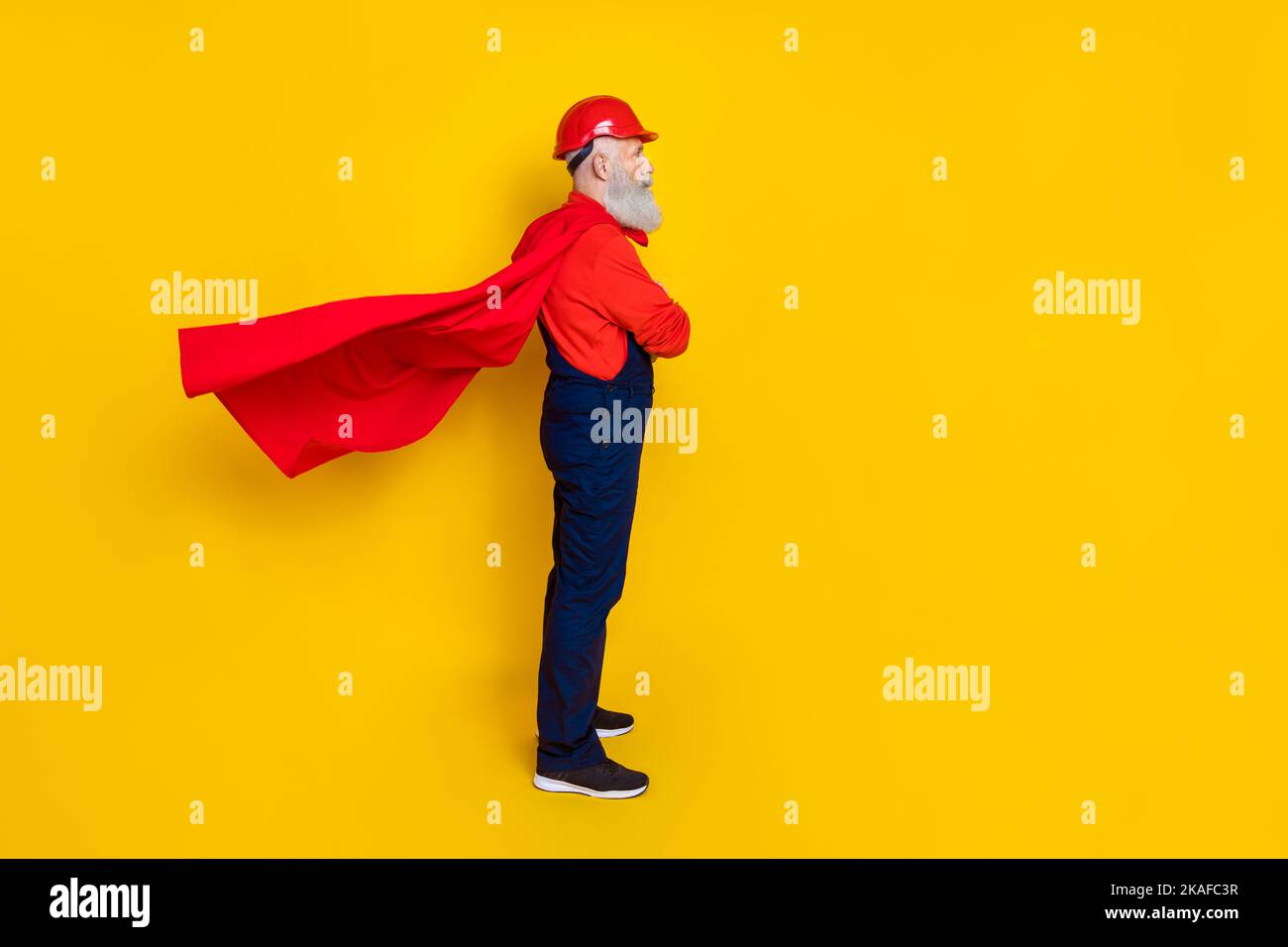 Photo of serious strong age man wear overall uniform red hard hat cape ...
