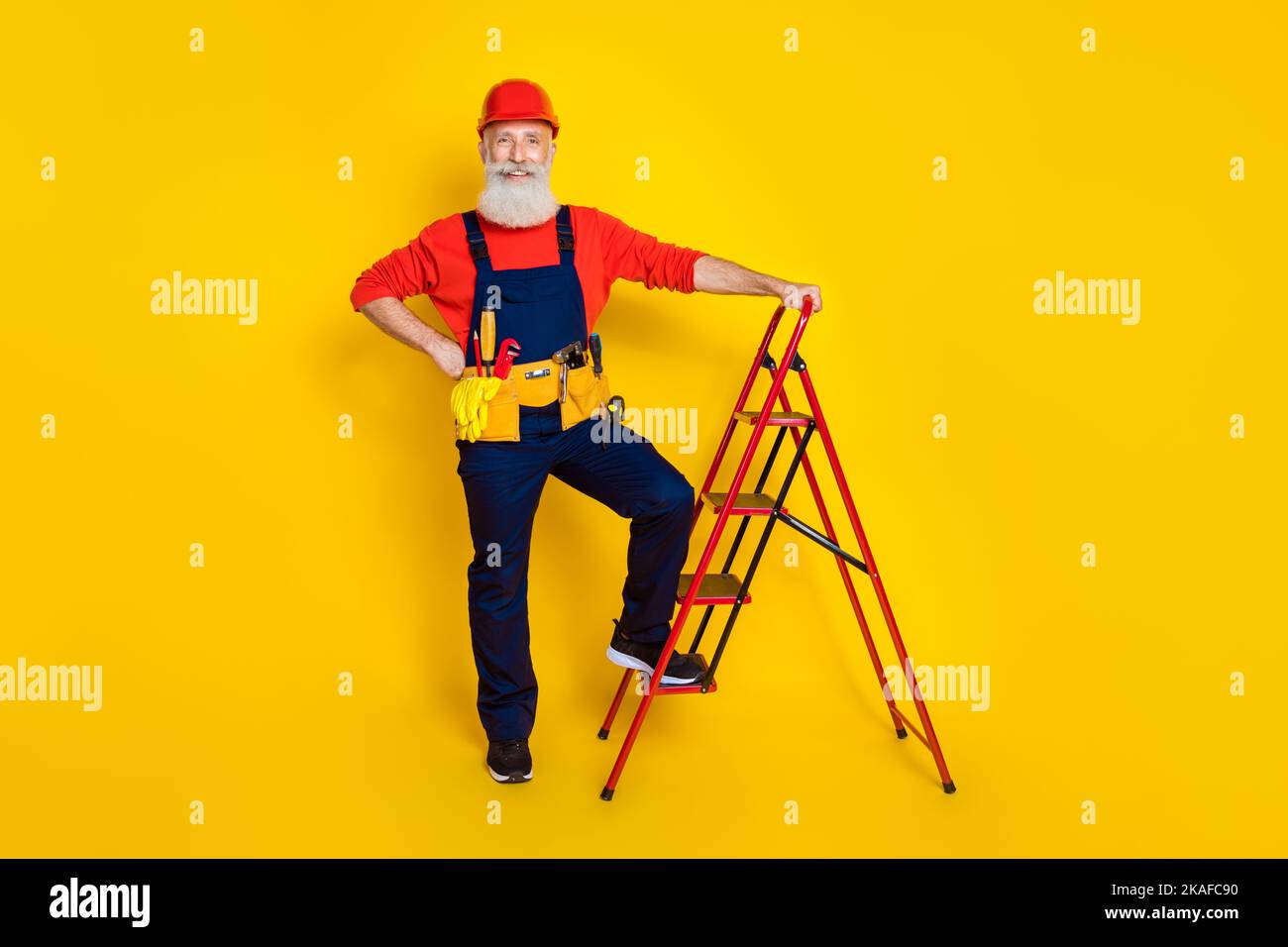 Full length photo of cheerful positive age man wear overall uniform red ...