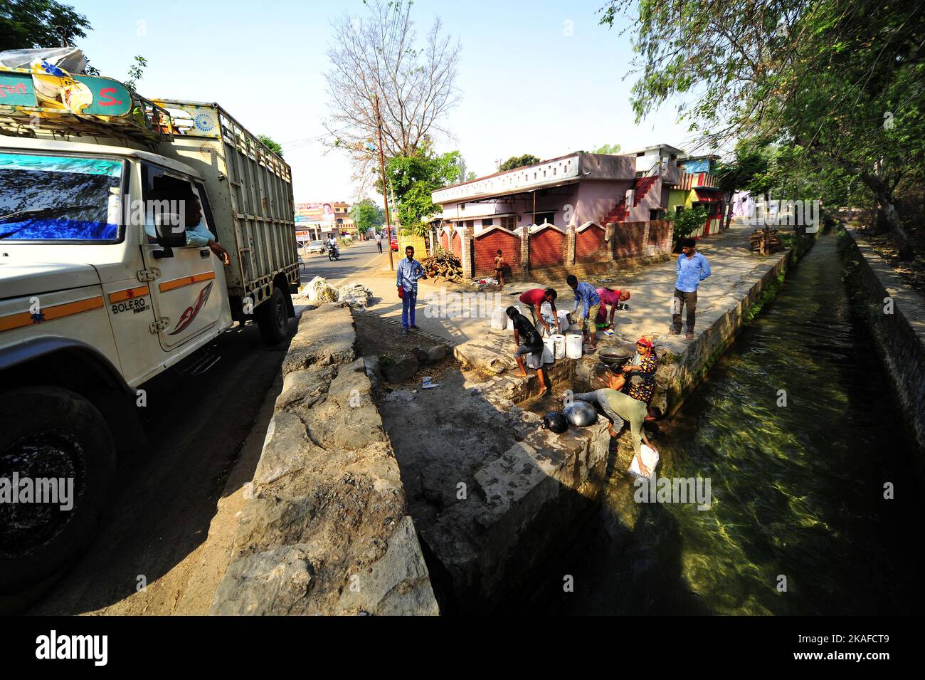 Indian people collecting water at the Boar canal, built by Sir Henry ...