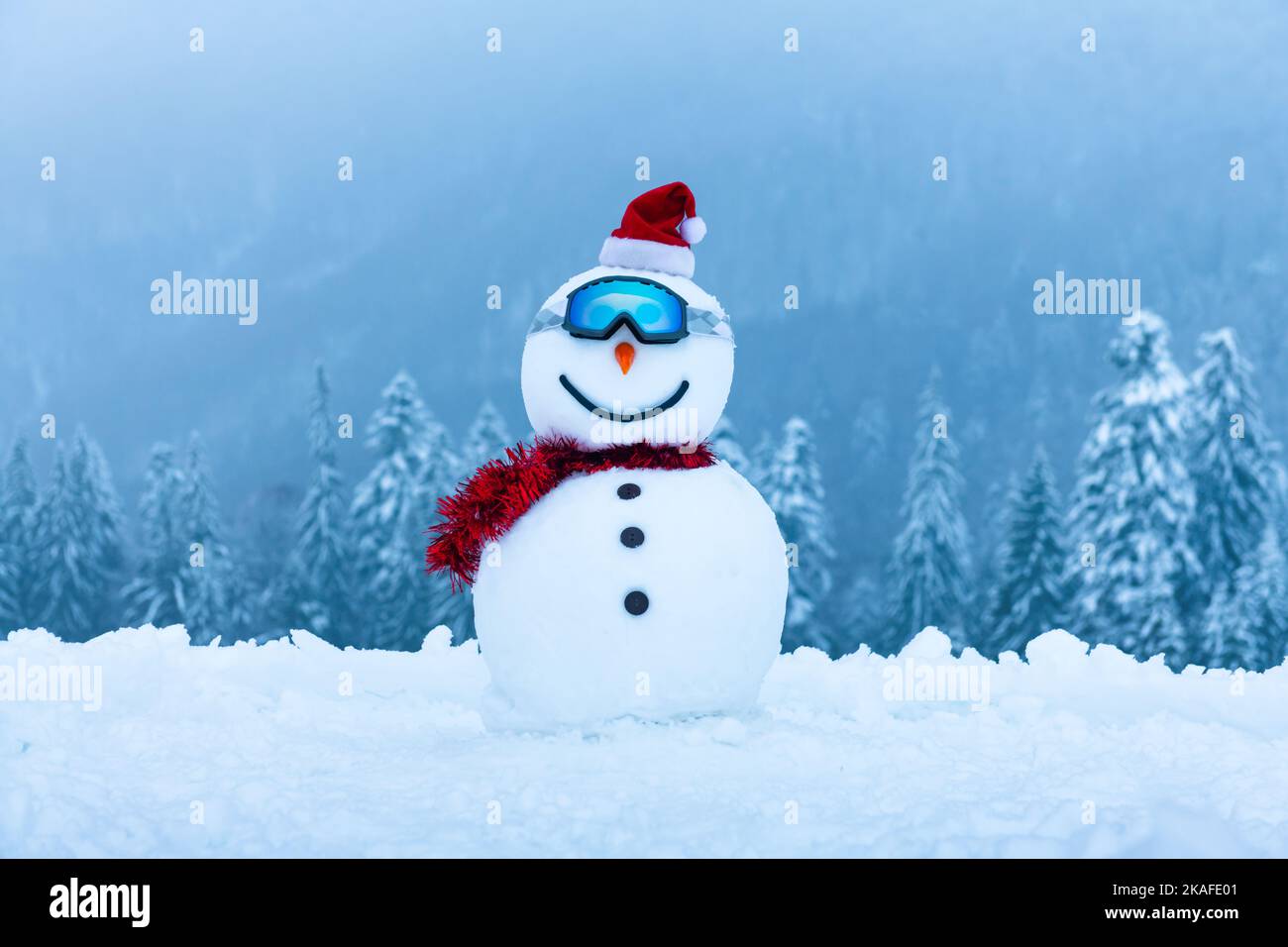 Funny snowman in ski glass in snowy mountains. Ski resort concept ...