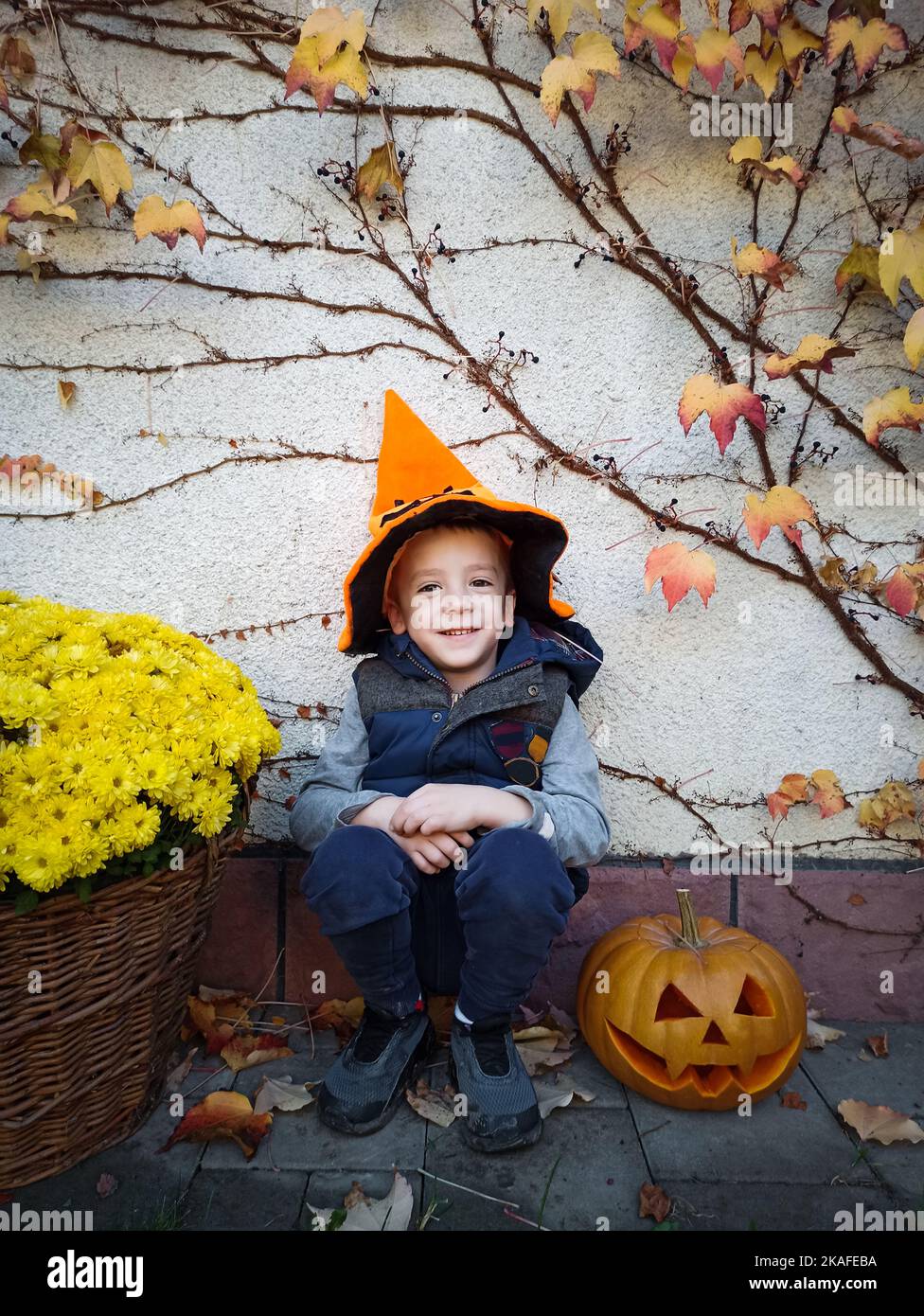 Cheerful Boy on Halloween holiday wearing orange pumpkin hat with jack ...