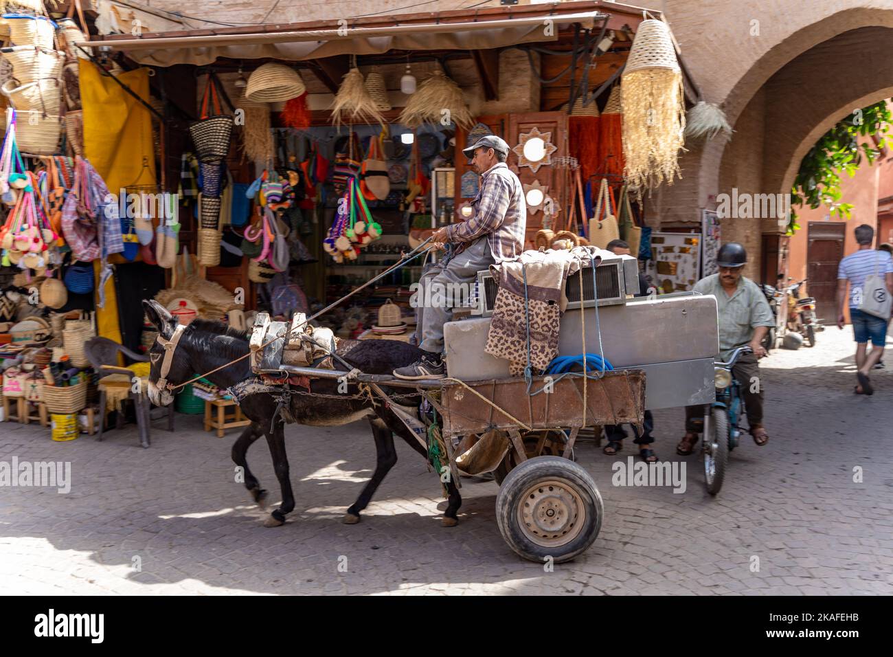 A man riding monkey towed car on the streets of Marrakech, Marocco ...