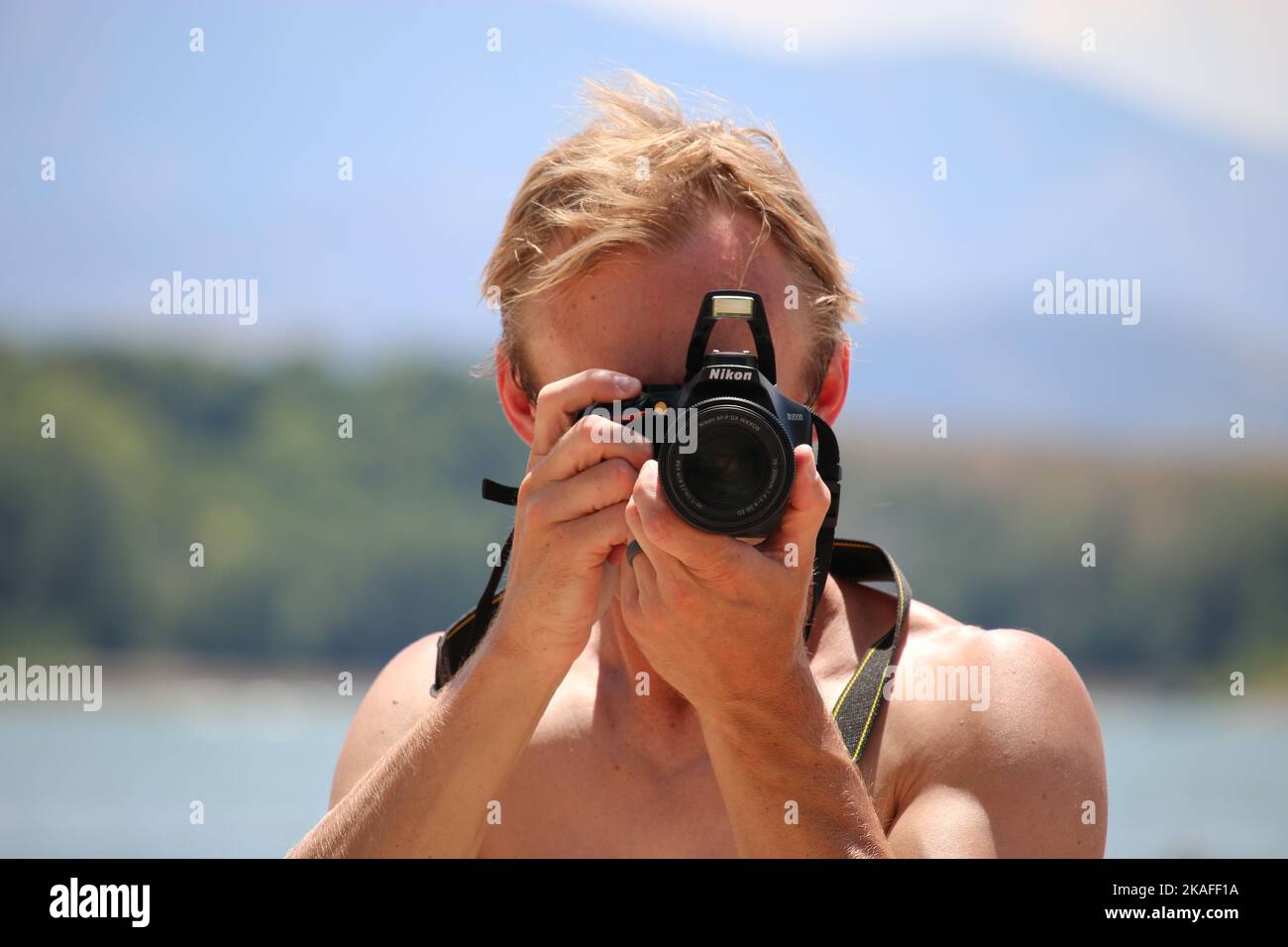 A close-up of a Man Shooting with a Nikon camera Stock Photo - Alamy