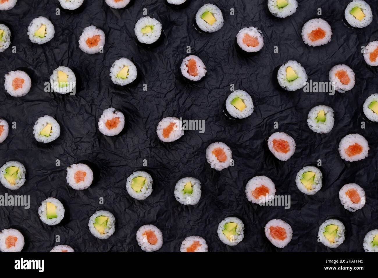 sushi maki rolls on black background top view ,fashion food background ...