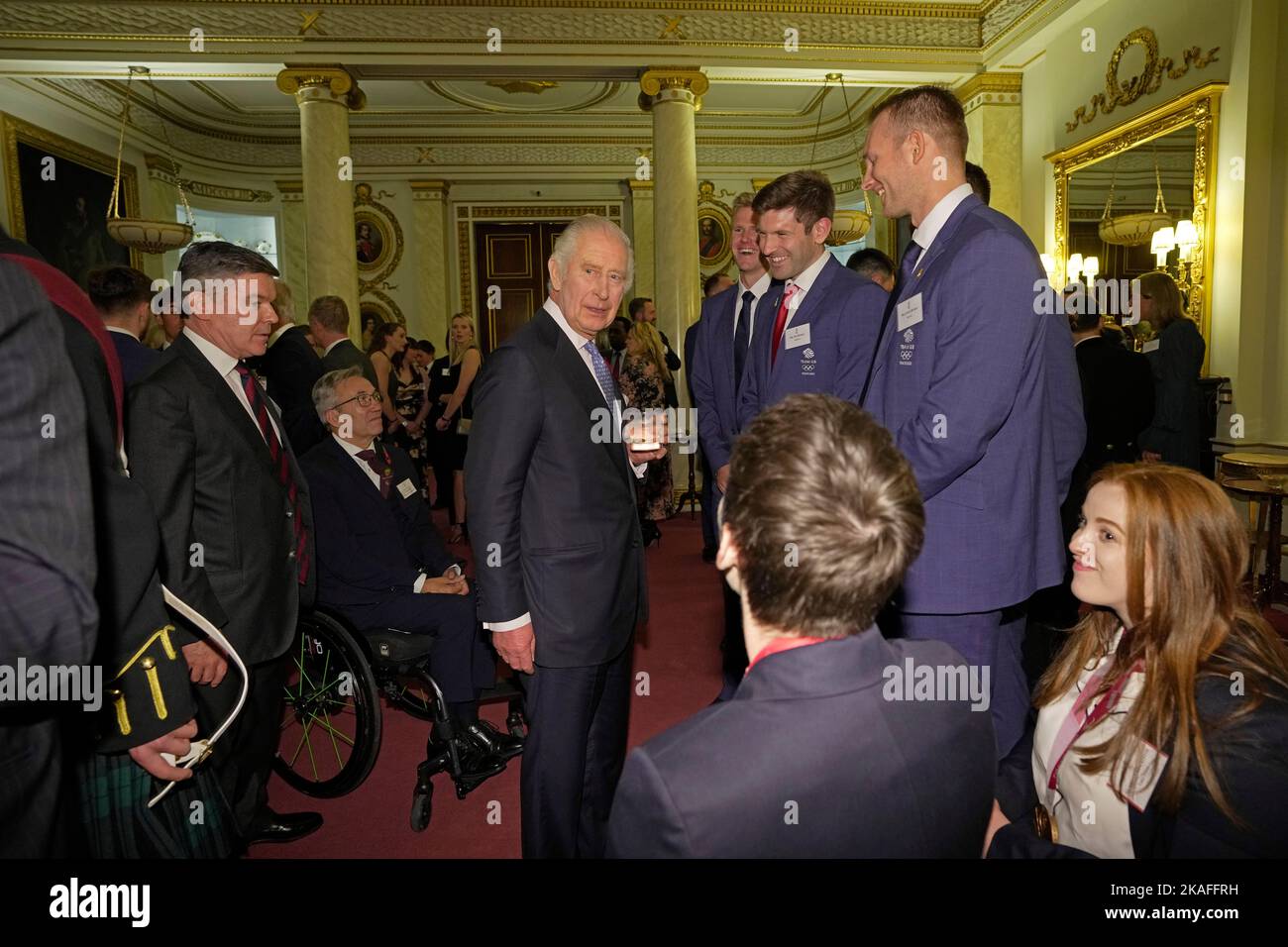 King Charles III speaks with guests during a reception for over 200 ...