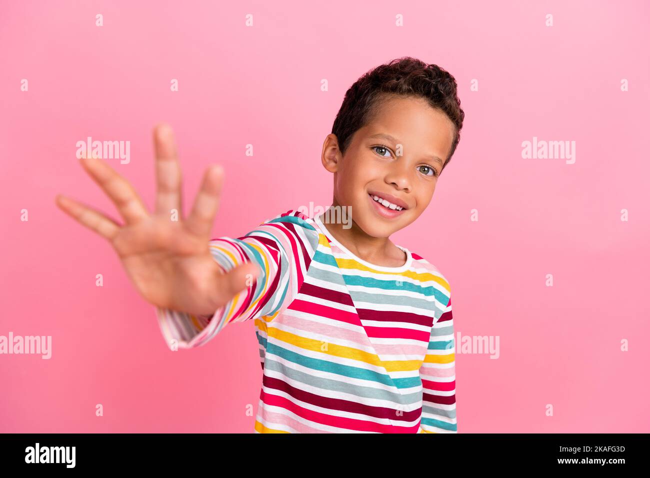 Portrait of attractive friendly cheerful boy give high five greetings ...
