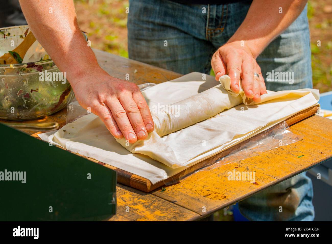 The female hands preparing the greek traditional dish Spanakopita ...