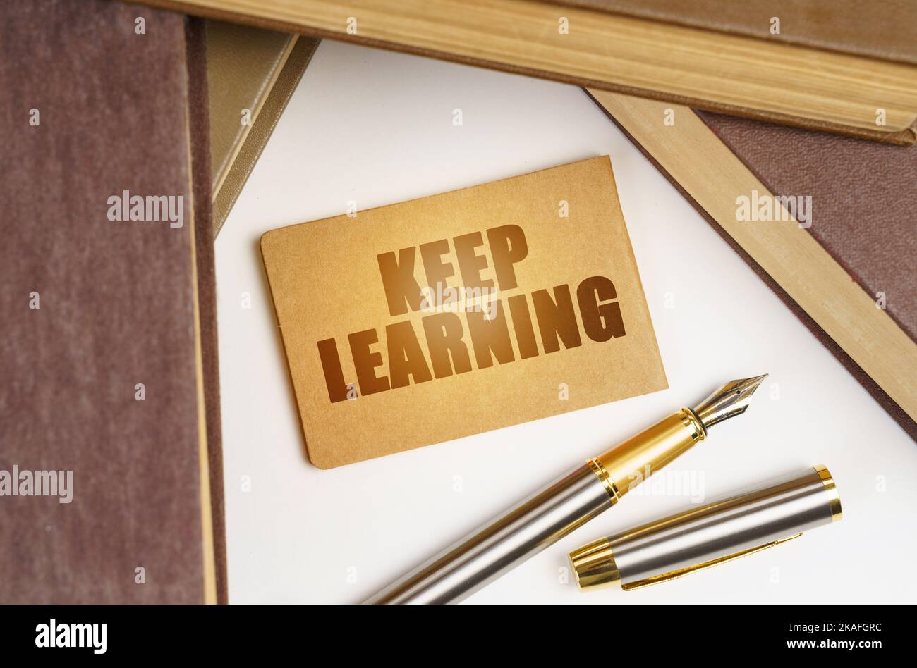 Education and business concept. Next to the books lies a pen and a sign ...