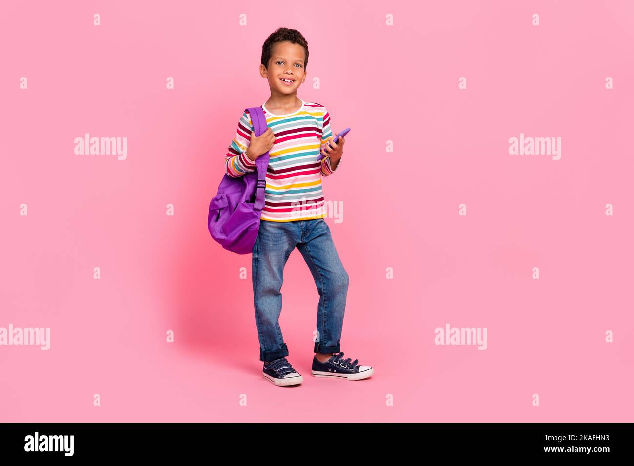 Full size photo of blogger boy wear striped shirt jeans bag pack ...