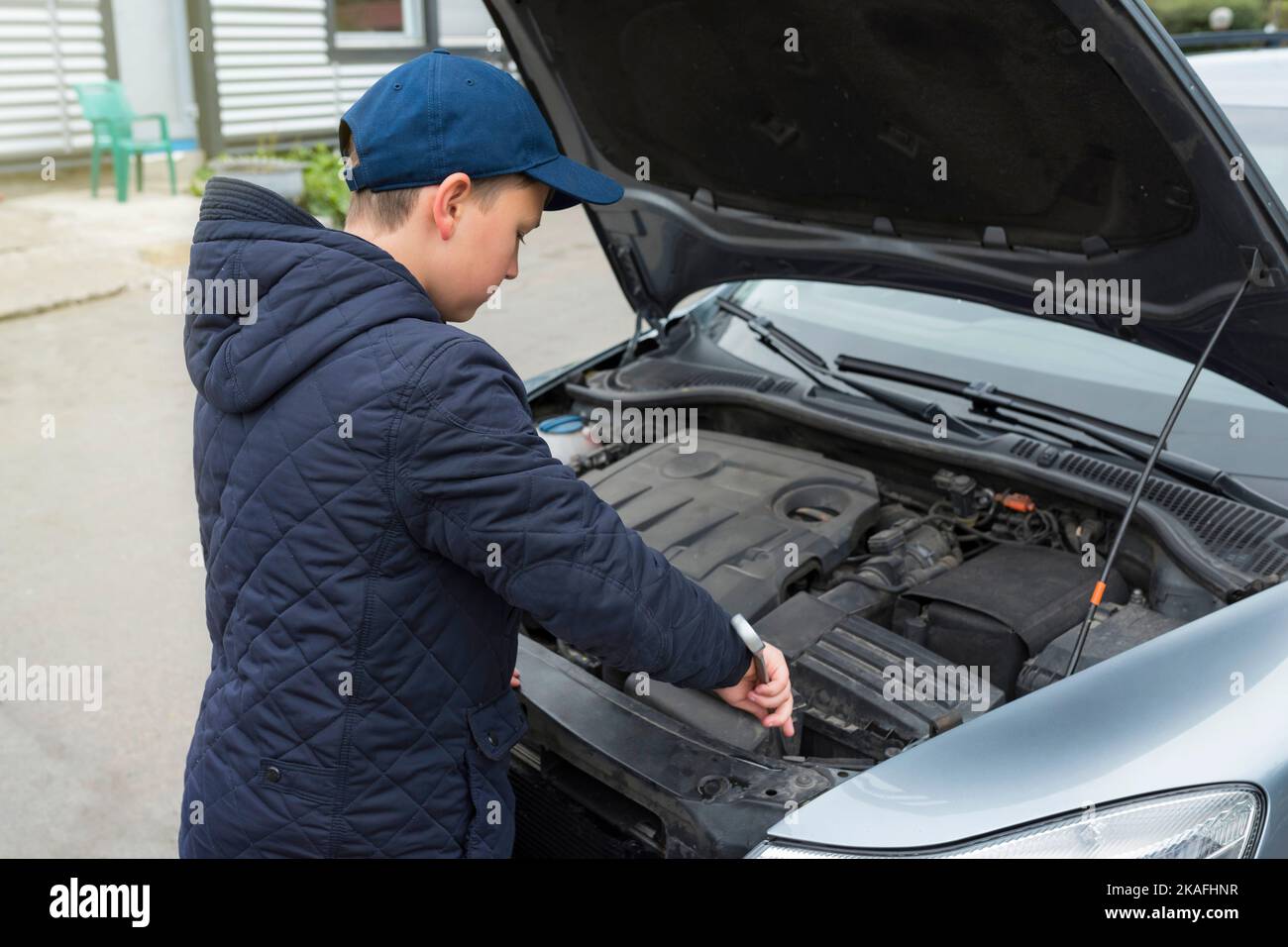 Children's car mechanic on the street repairing a car. The view from ...