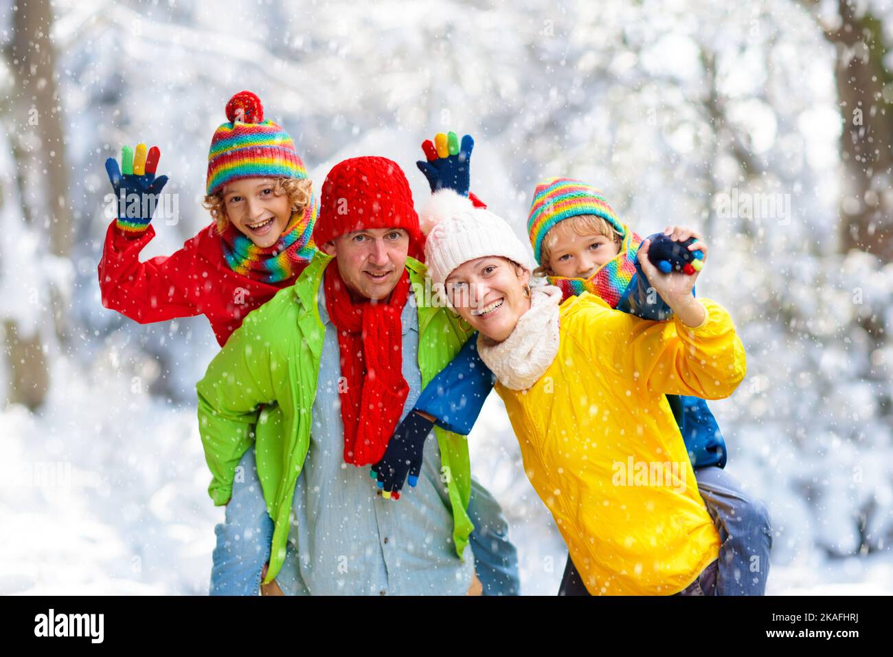 Family in winter park. Snow fun with kids. Mother, father and children ...