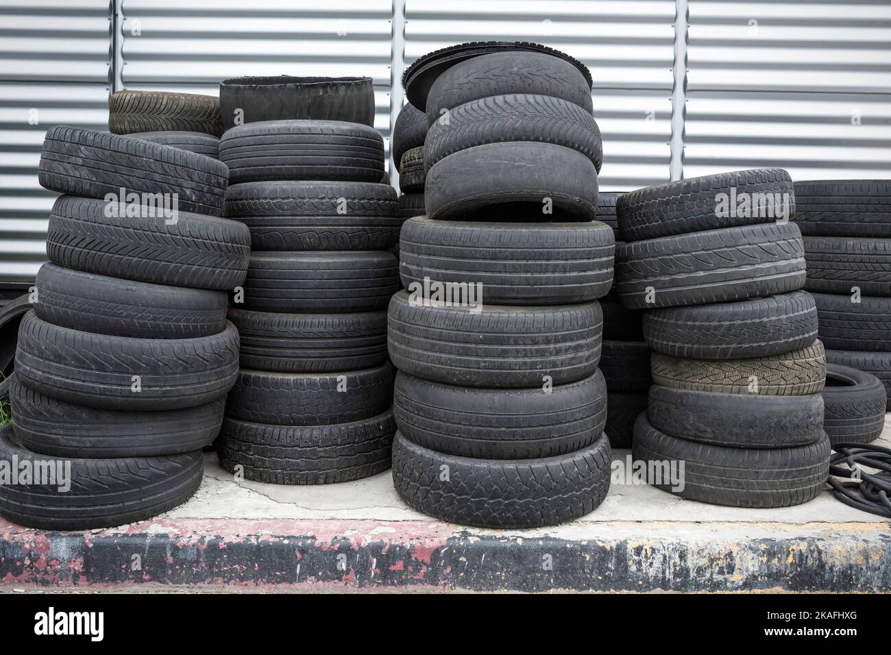 Old used tires stacked. Black piles of used tires Stock Photo - Alamy