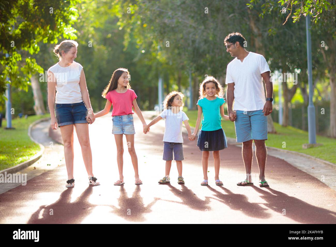 Family walking in summer park. Parents and kids outdoor. Mother, father ...