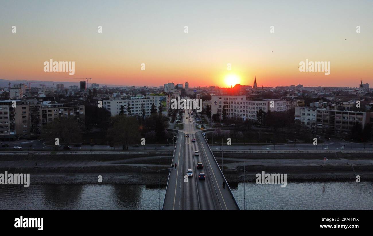 The urban view of the cars crossing the bridge with the sunset ...