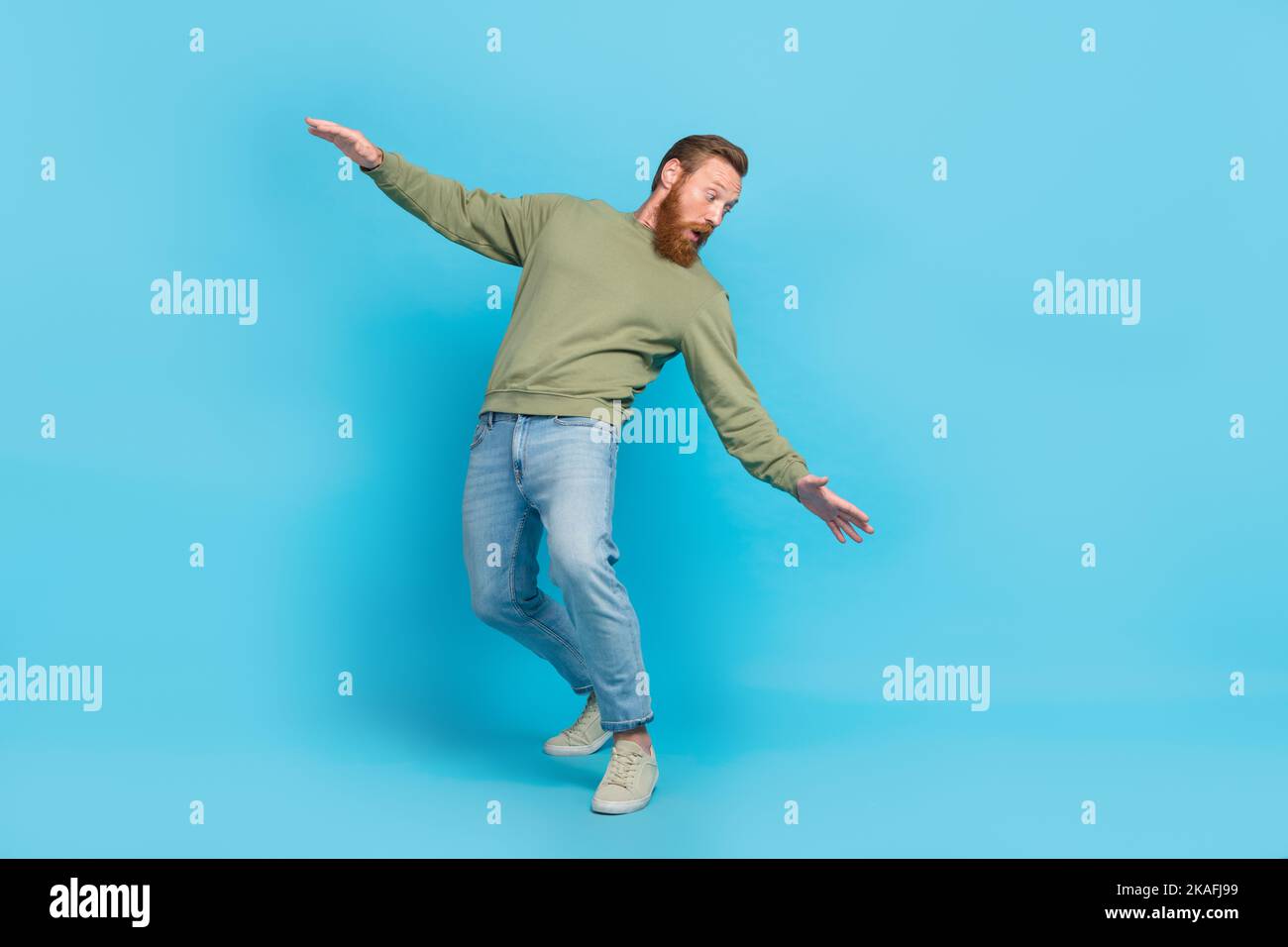 Full size photo of handsome young man bending look back avoid falling ...