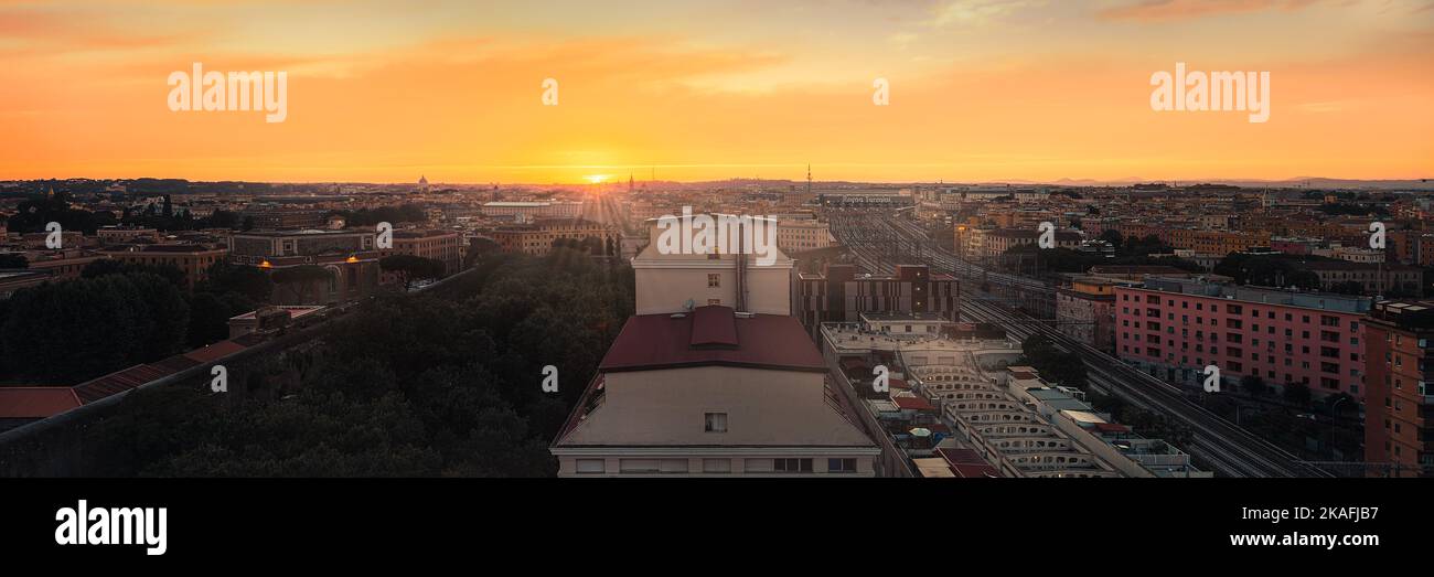 An aerial view of cityscape Rome surrounded by buildings during sunset ...