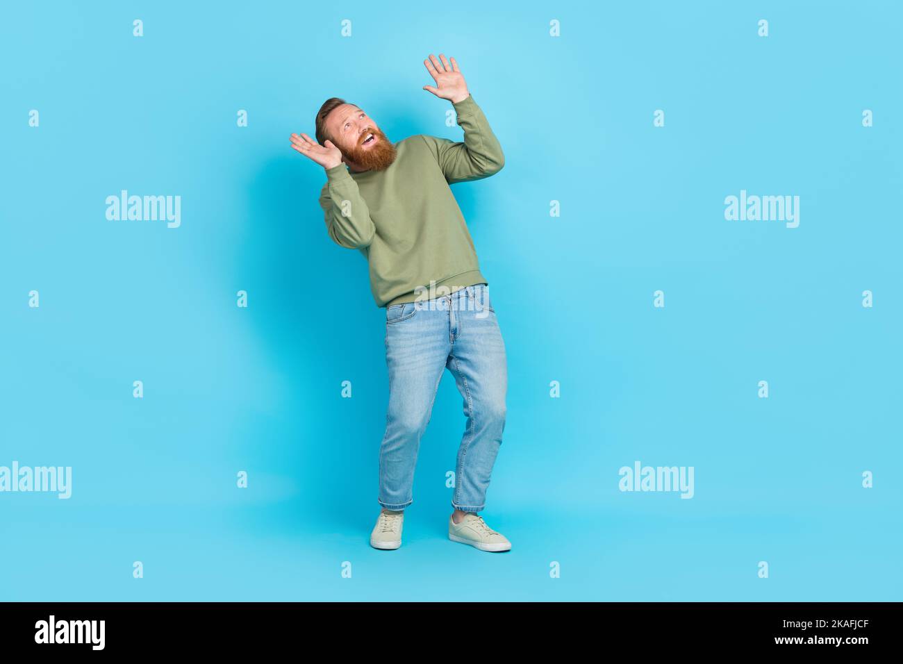 Full body photo of attractive young man afraid dangerous above look up ...