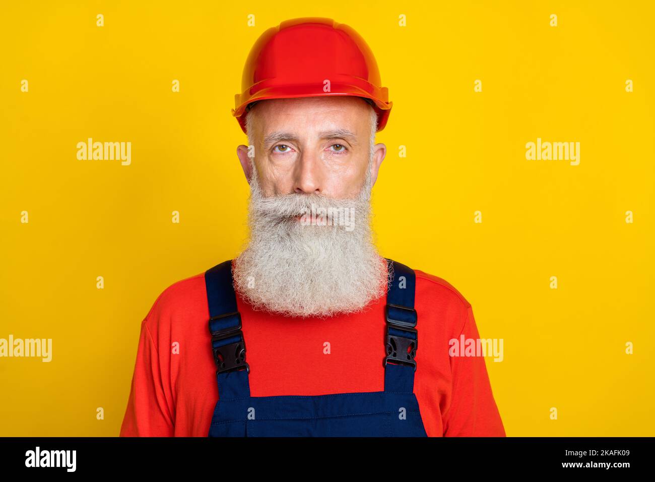 Photo of serious confident age man workwear uniform red hard hat ...