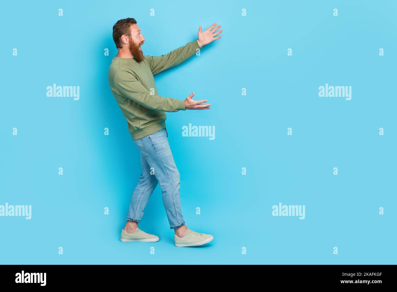 Full body photo of attractive young guy excited stretching arms meet ...