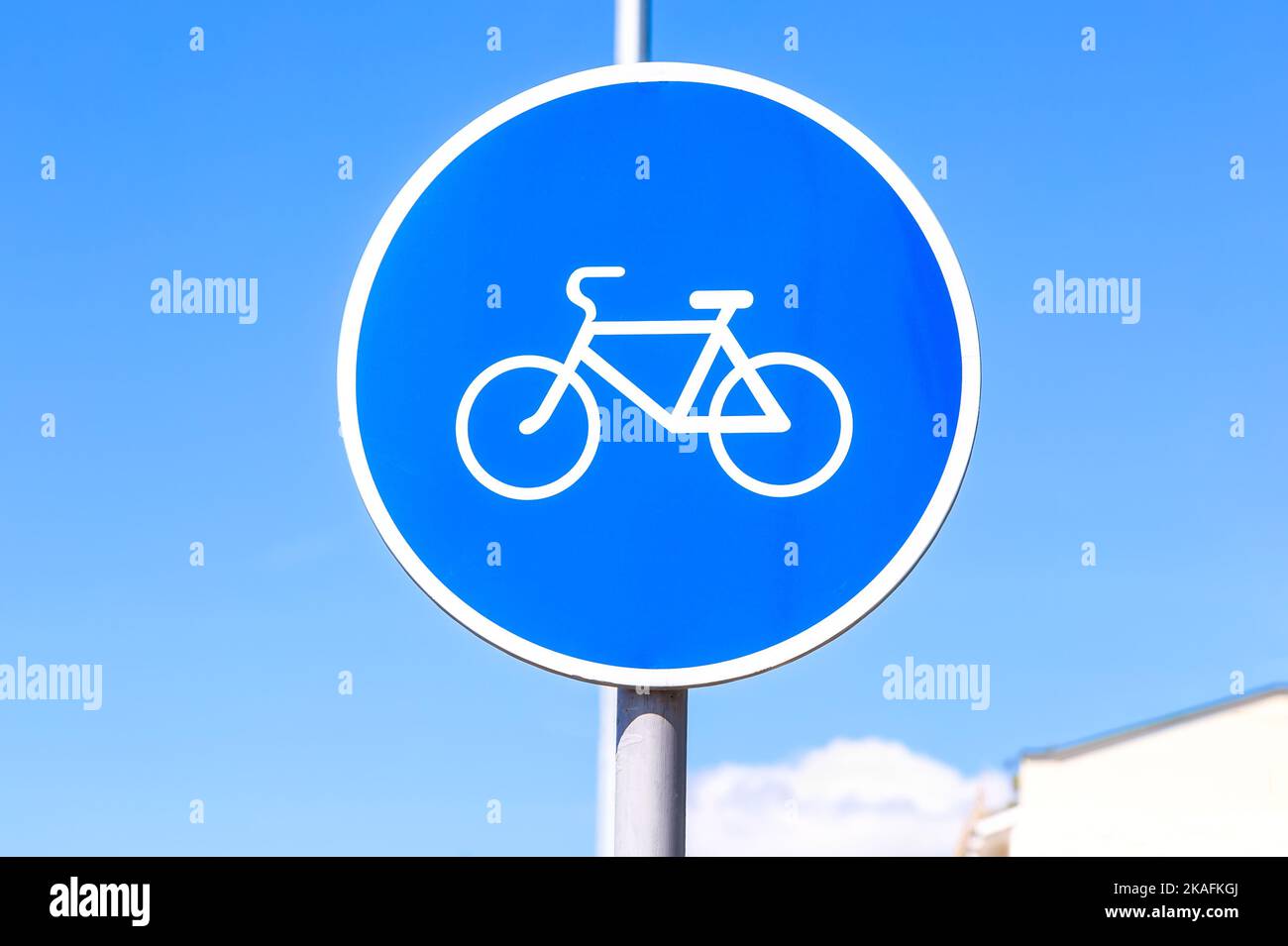 Bicycle road sign for bikes lane against the blue sky Stock Photo - Alamy