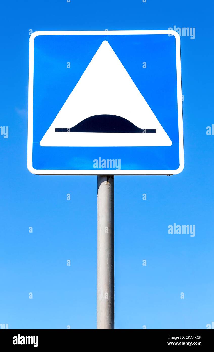 Triangle speed bump road sign against the blue sky. Warning traffic sign Speed bump Stock Photo ...