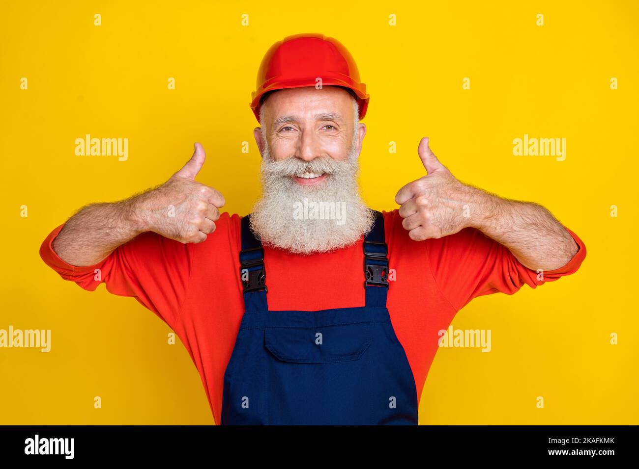 Photo of positive funky age man workwear overall red hard hat showing ...
