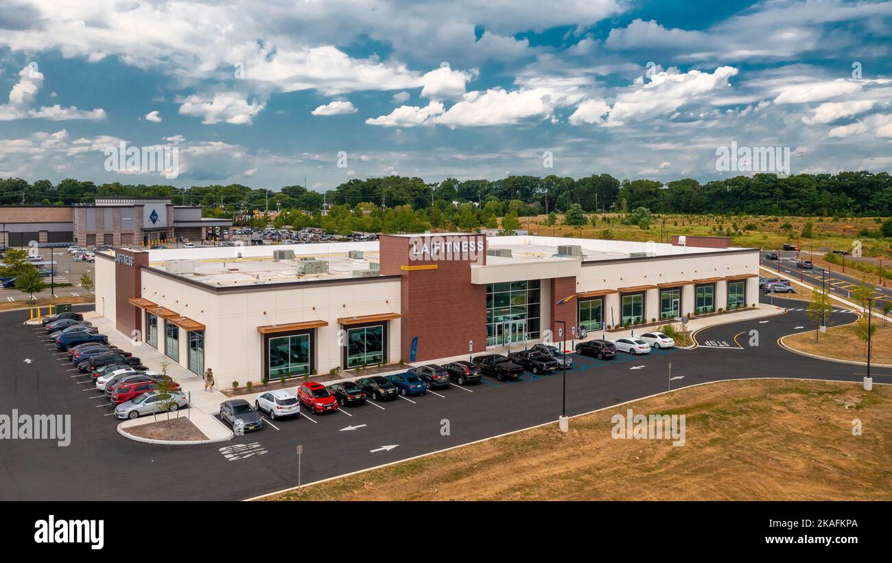 A wide angle aerial view of La Fitness Gym building with cars parked in ...