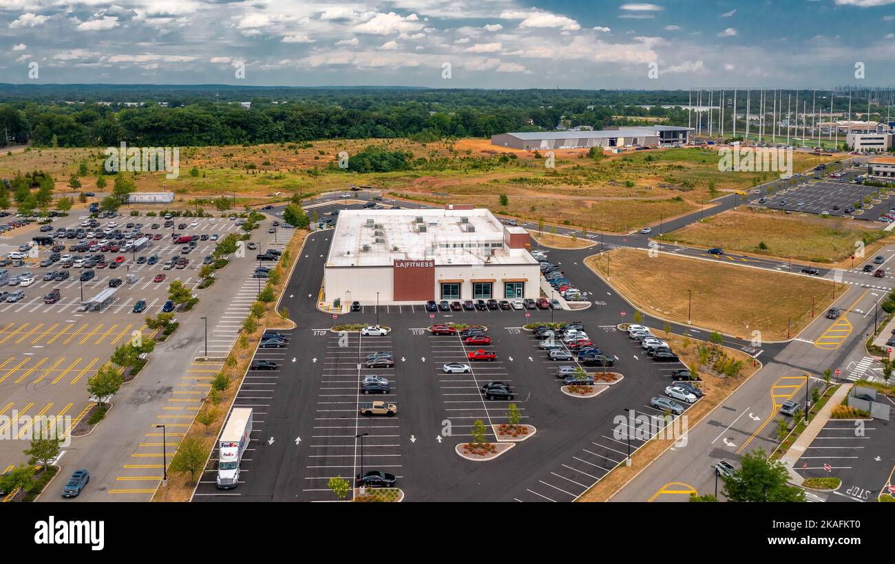 A wide angle aerial view of La Fitness Gym building with cars parked in ...
