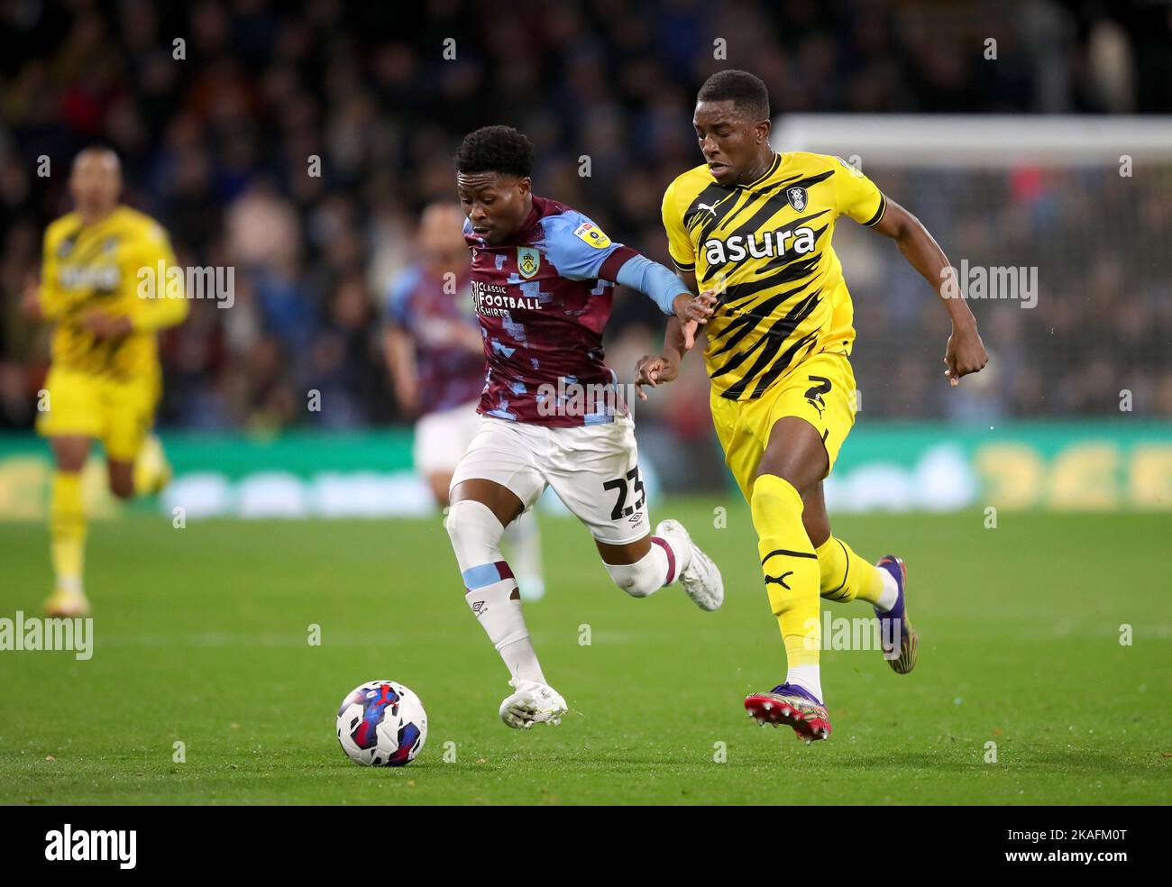 Burnley's Nathan Tella (left) and Rotherham United's Wes Harding battle ...