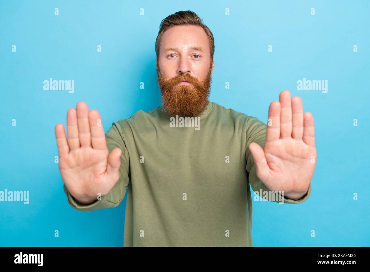 Photo of serious man dressed khaki sweatshirt show two arm please keep ...