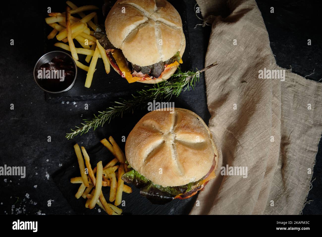burgers and fries on a wooden background Stock Photo - Alamy